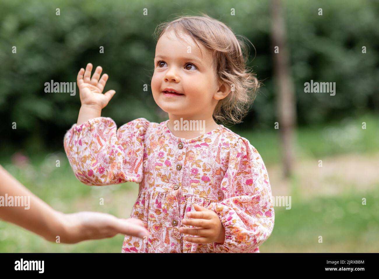 Smiling child hand outdoors hi-res stock photography and images - Alamy