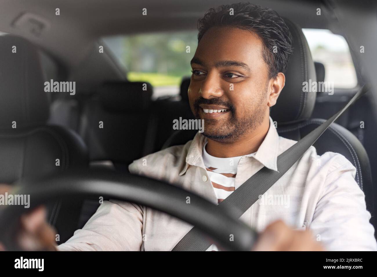 smiling indian man or driver driving car Stock Photo - Alamy