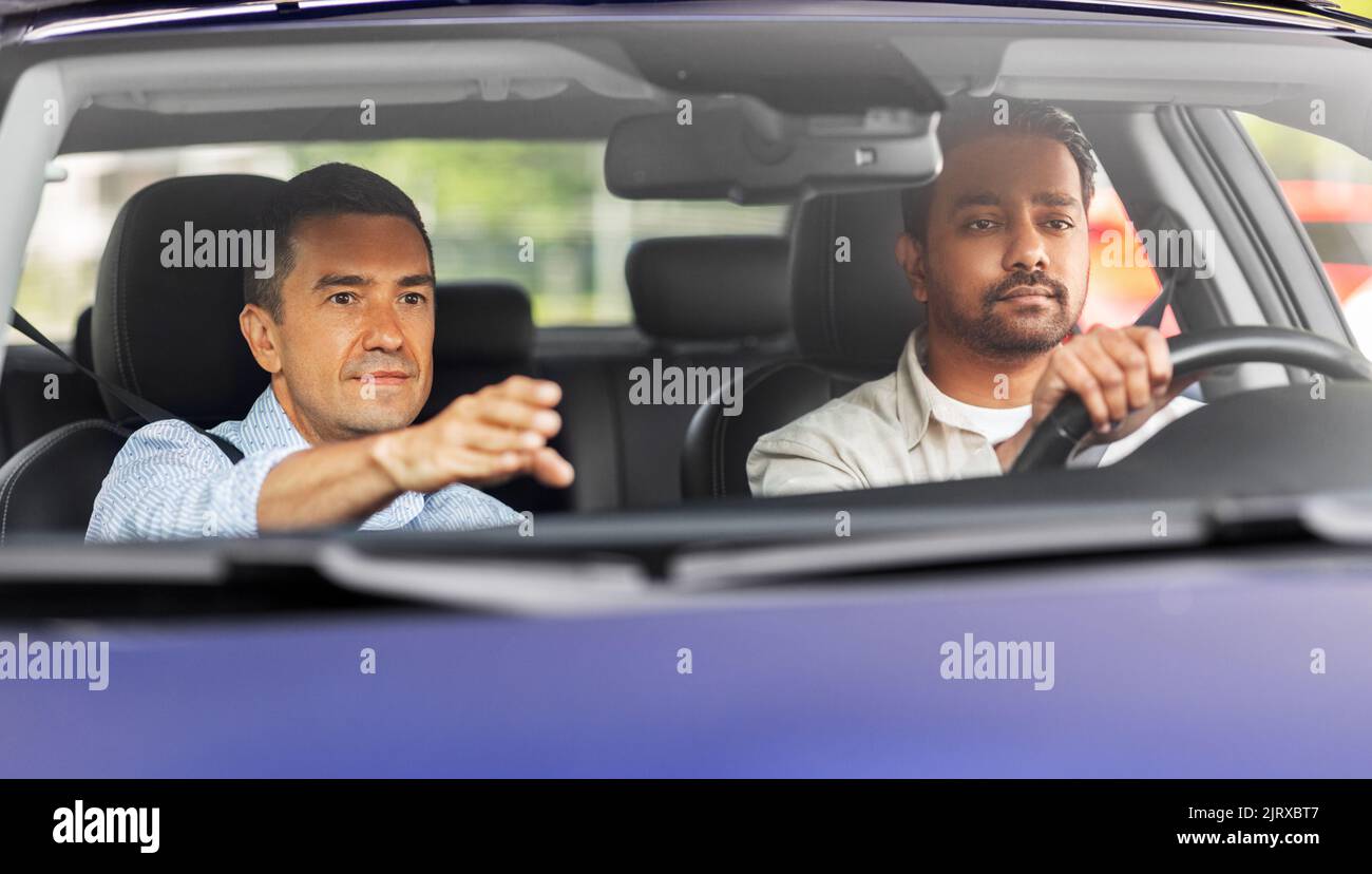 car driving school instructor teaching male driver Stock Photo - Alamy