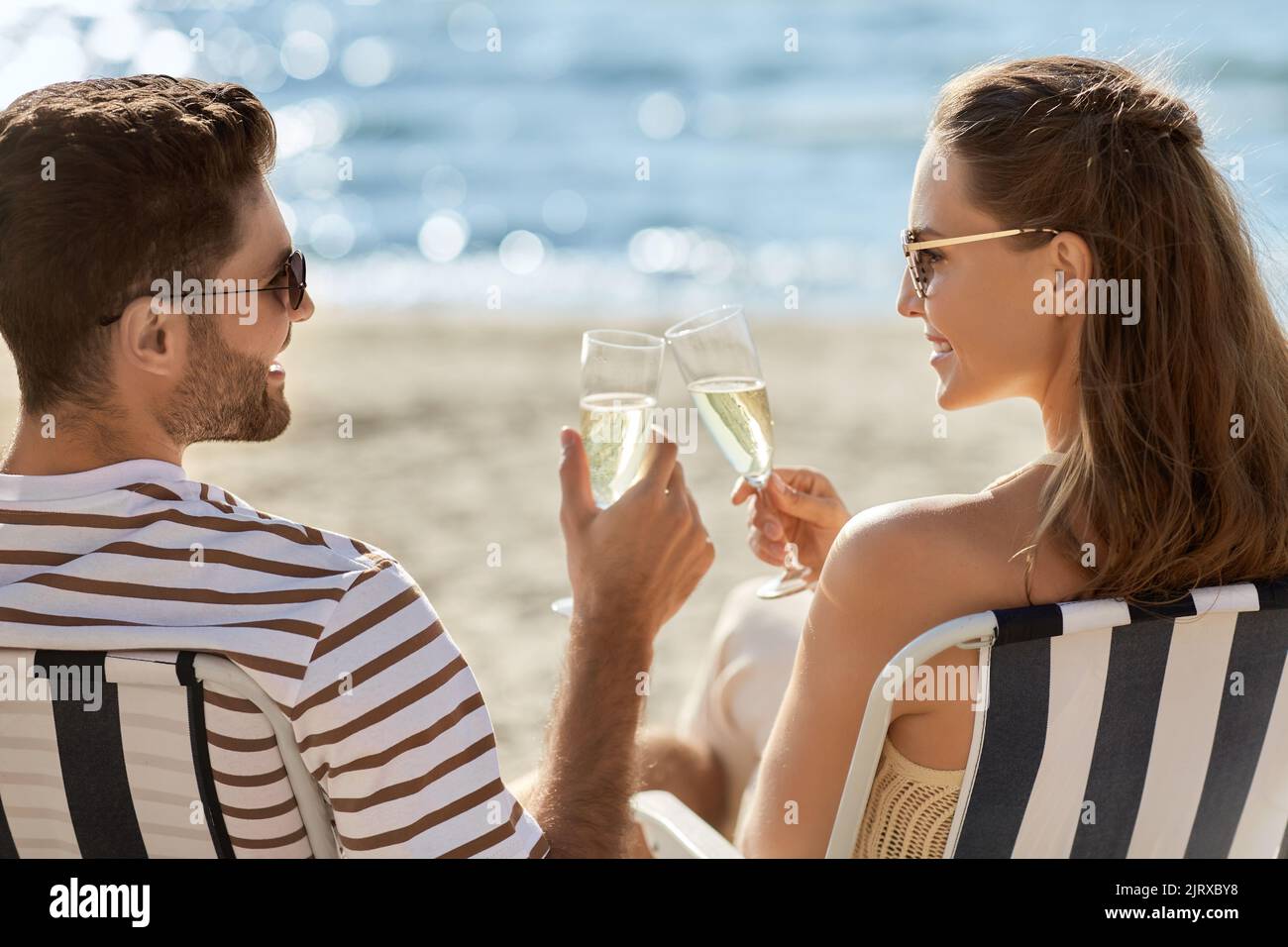 happy couple drinking champagne on summer beach Stock Photo - Alamy