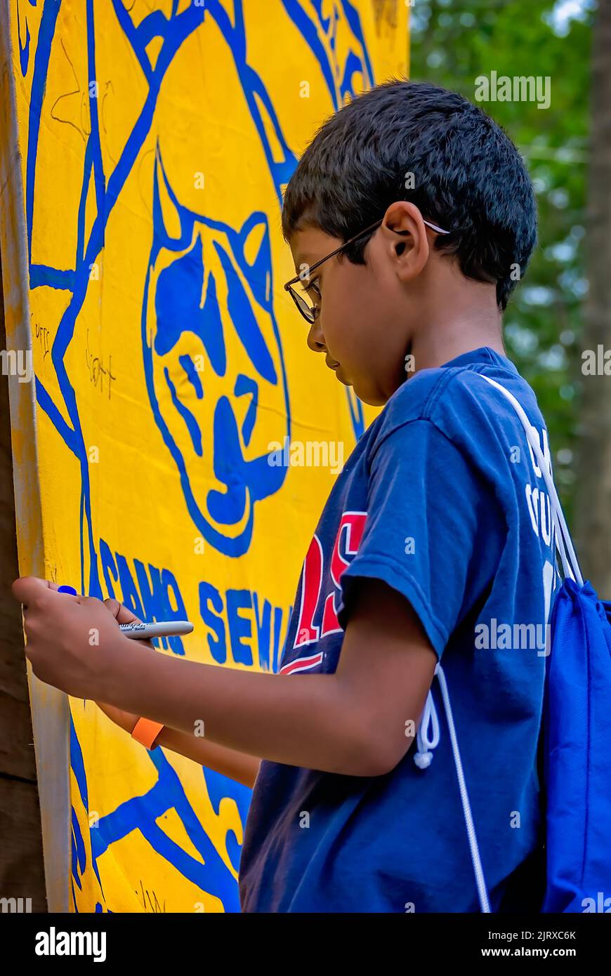 A Cub Scout signs a flag at Camp Seminole, June 24, 2011, Starkville ...