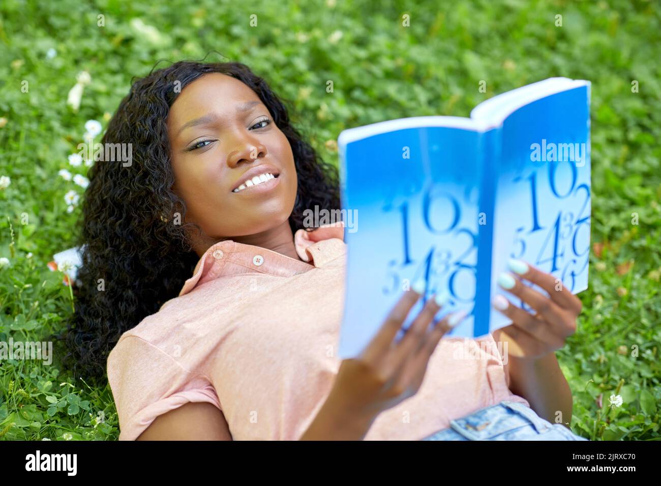 african student girl reading math textbook Stock Photo - Alamy