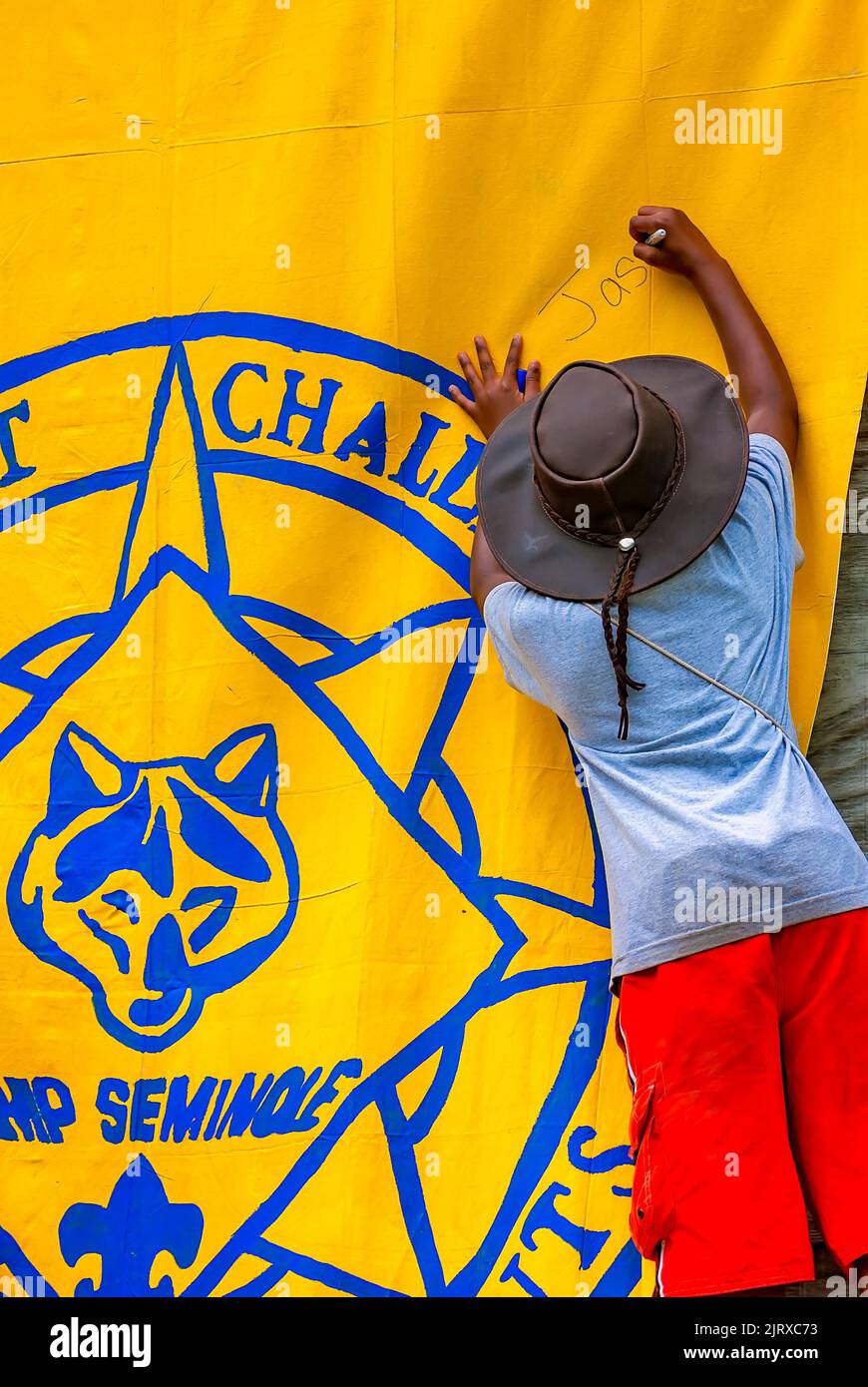 A Cub Scout signs a flag at Camp Seminole, June 24, 2011, Starkville ...