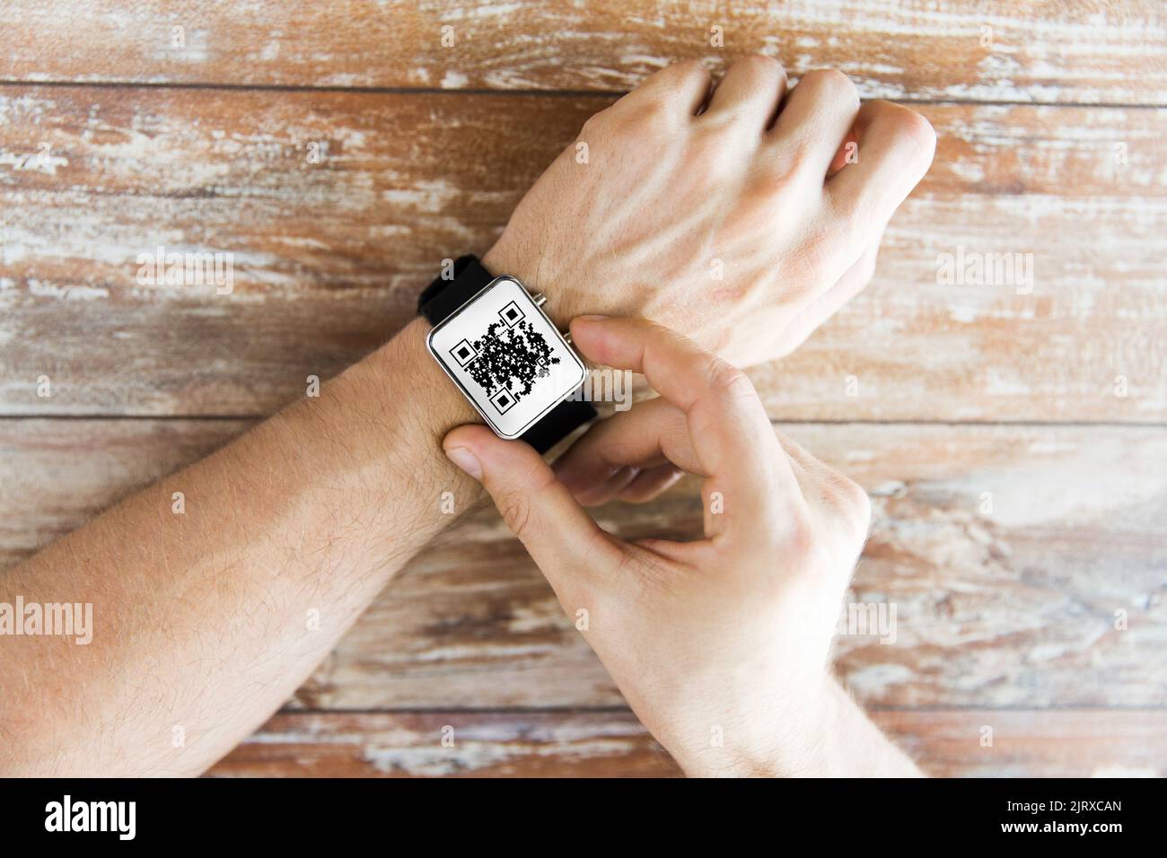 male hands with qr code on smart watch Stock Photo - Alamy