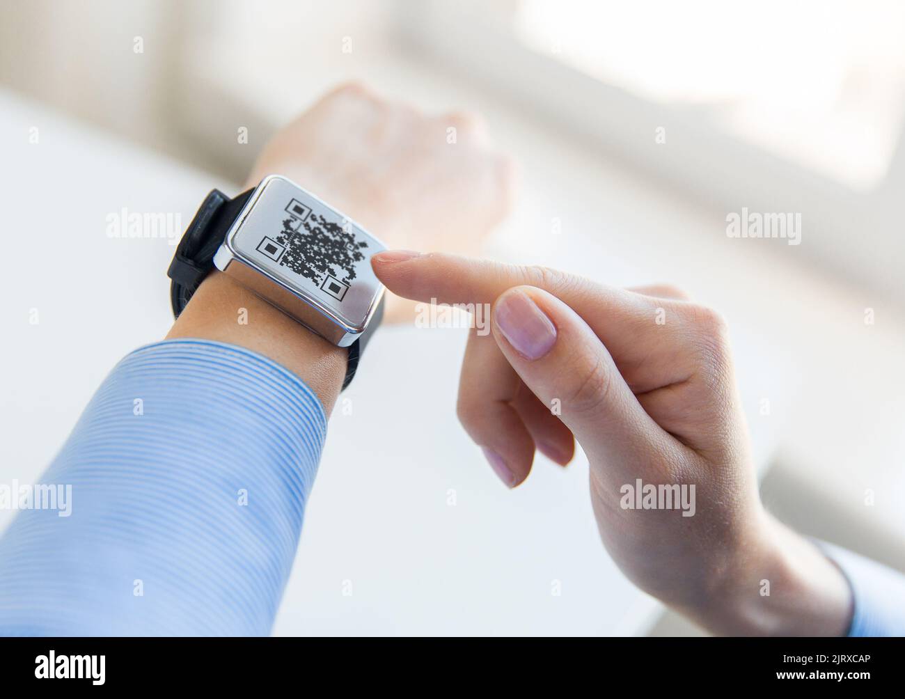 woman's hands with qr code on smart watch Stock Photo - Alamy