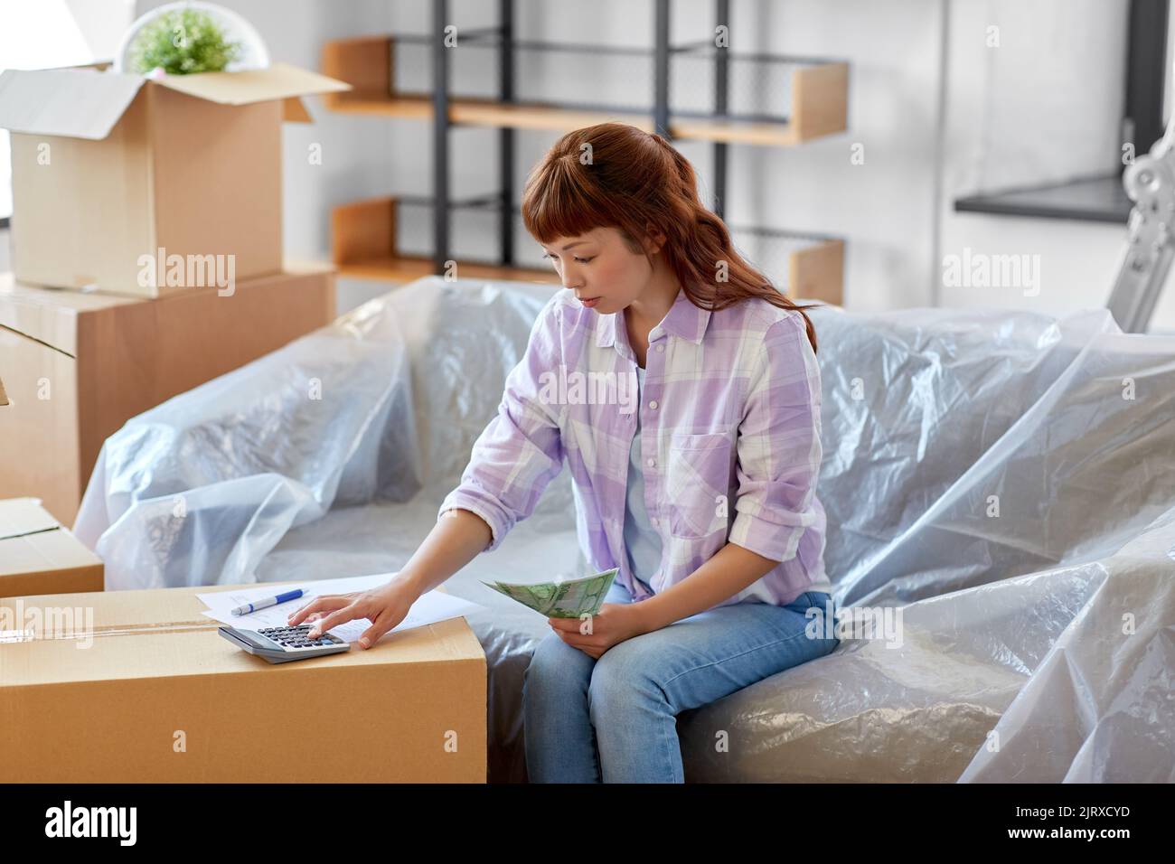 asian woman moving to new home and counting money Stock Photo - Alamy