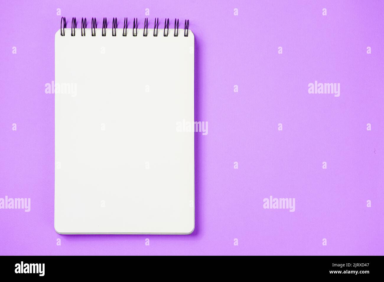 School notebook on a paper pink background, spiral notepad and craft ...
