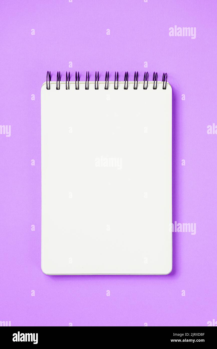 School notebook on a paper pink background, spiral notepad and craft ...