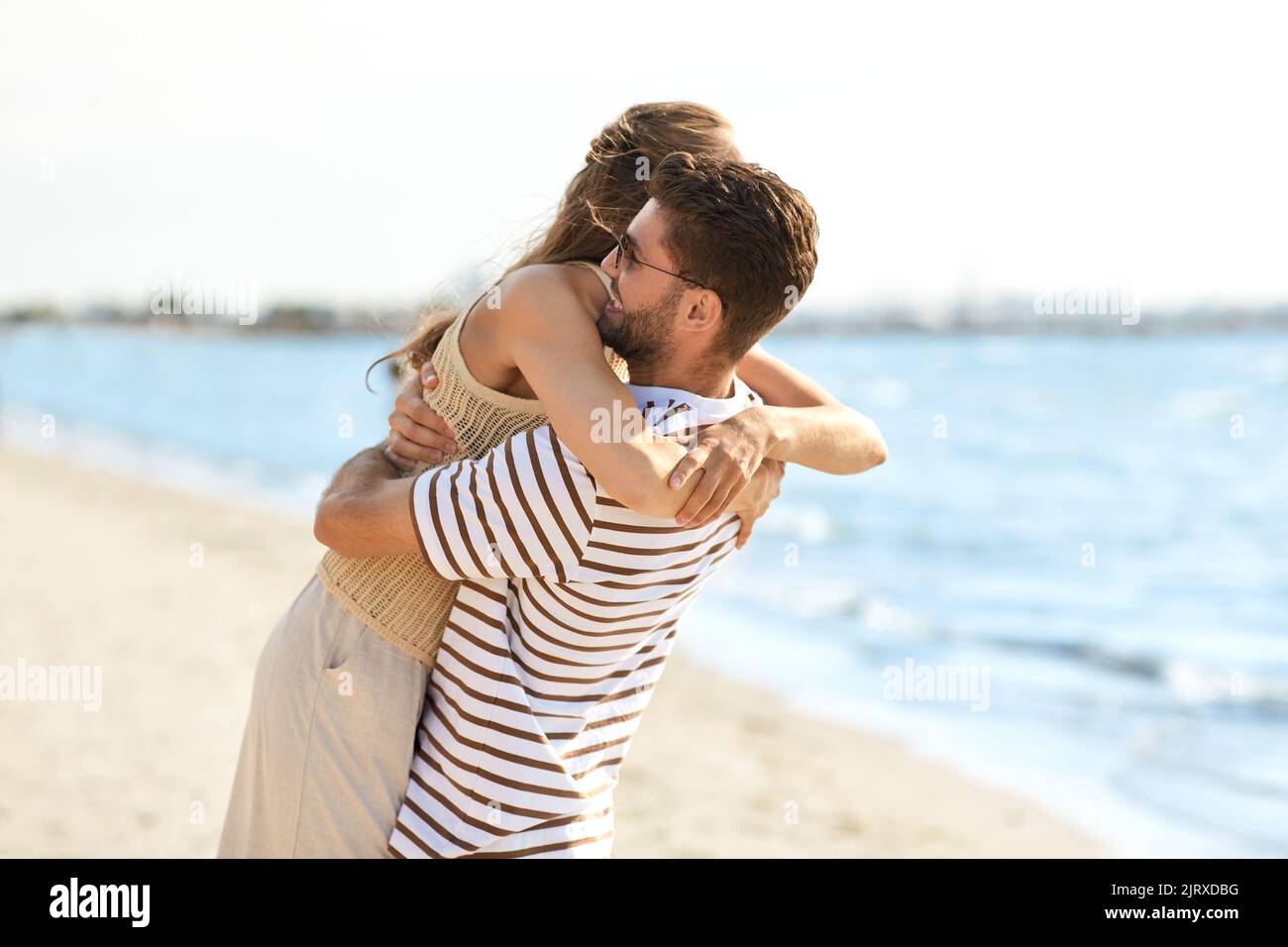 happy couple hugging on summer beach Stock Photo - Alamy