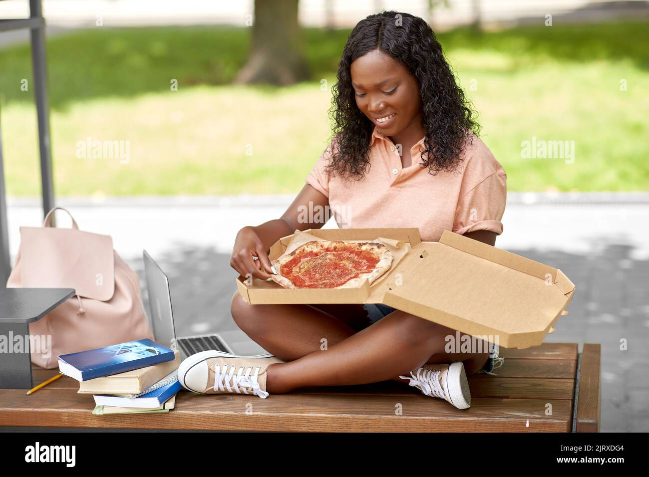 african student girl eating takeaway pizza in city Stock Photo - Alamy