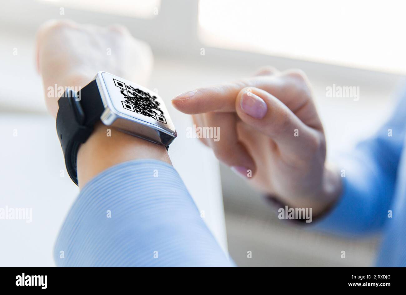 woman's hands with qr code on smart watch Stock Photo - Alamy