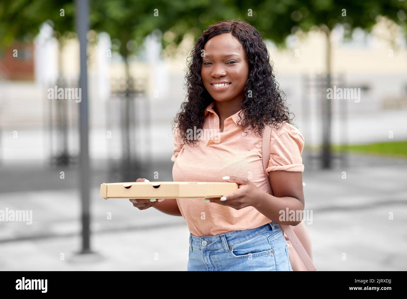 african student girl with takeaway pizza in city Stock Photo - Alamy
