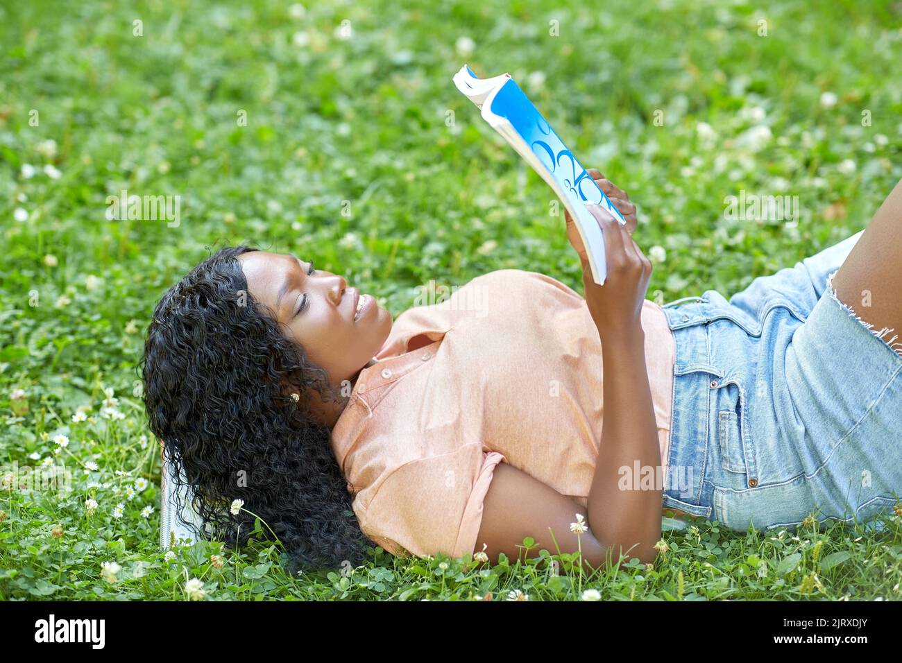 african student girl reading math textbook Stock Photo - Alamy