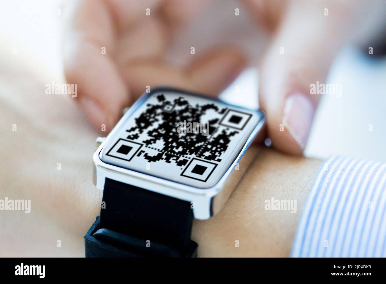 woman's hands with qr code on smart watch Stock Photo - Alamy