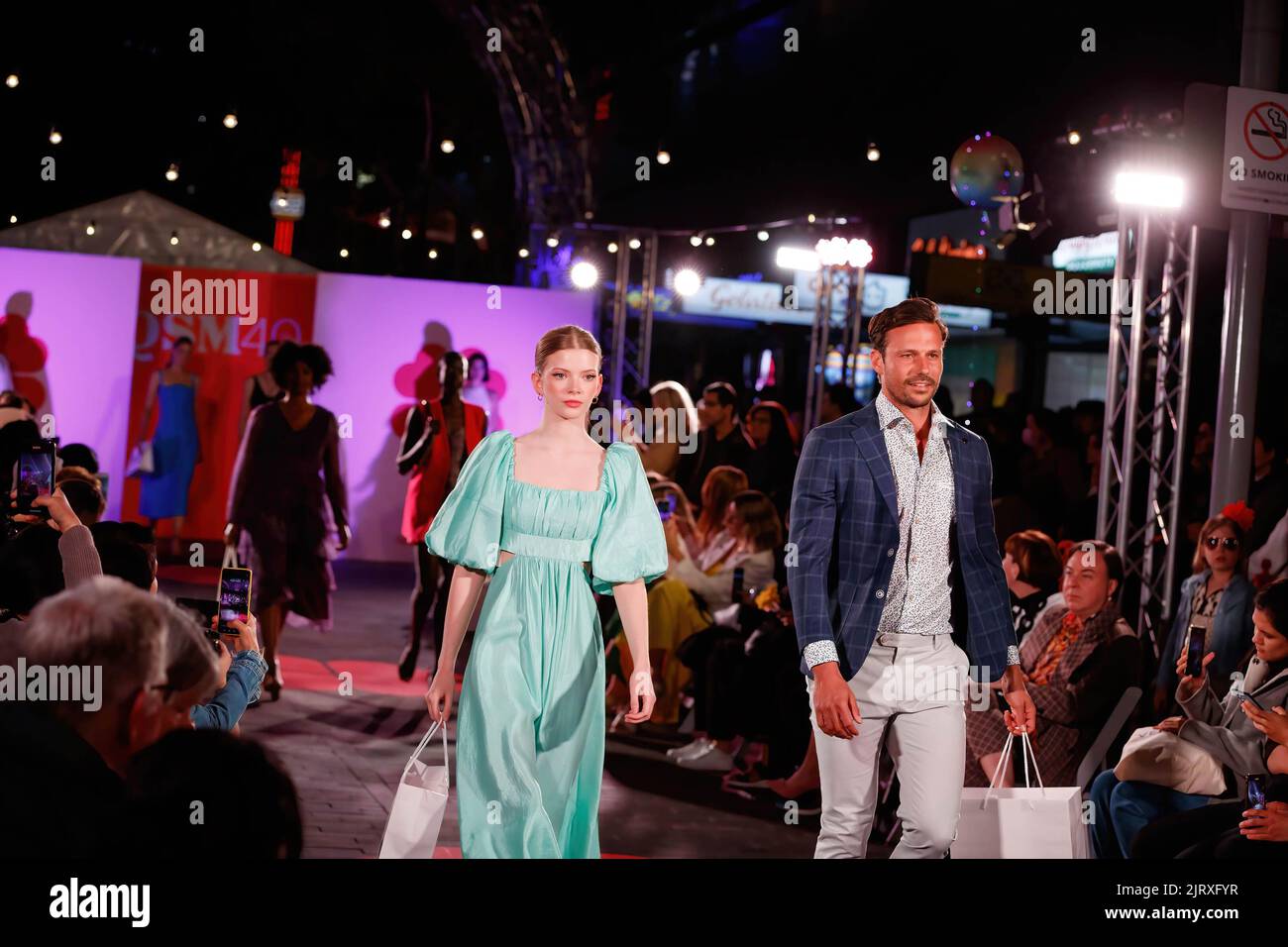 Models walk a fashion runway showcasing brands from local and ...