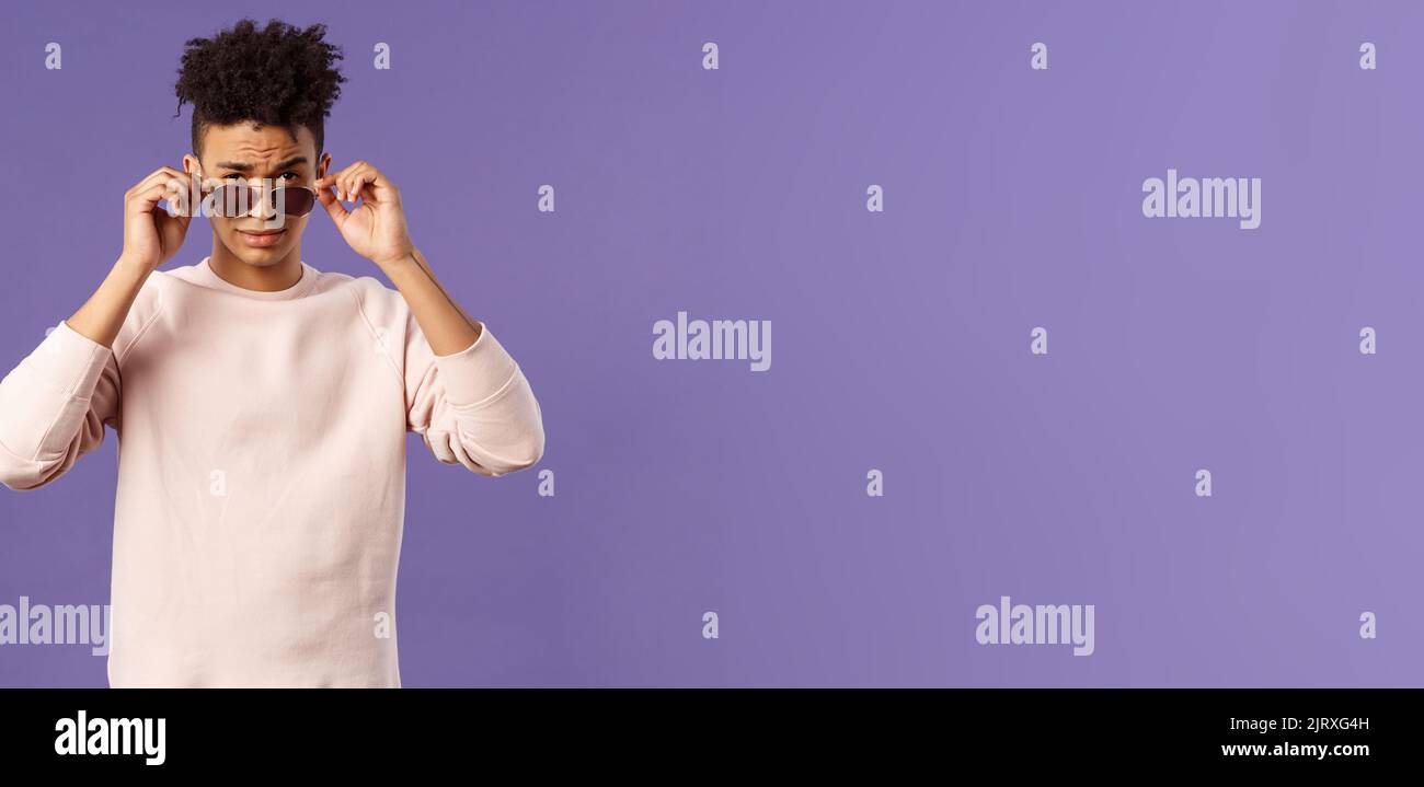 Portrait of sassy and confident young judgemental man, taking-off ...