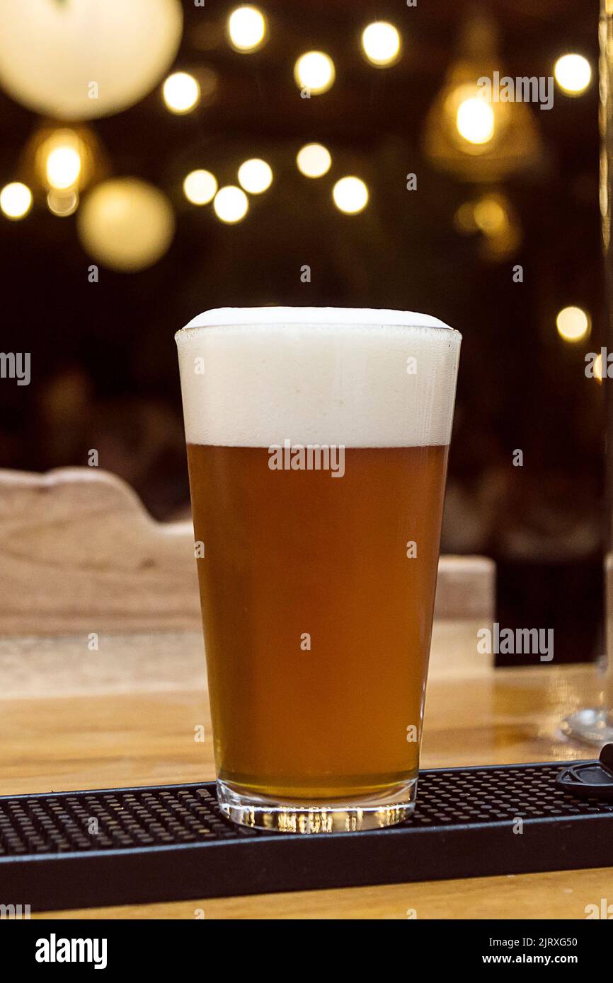 Craft beer served in a glass with foam. Nightlife. Brew house Stock ...