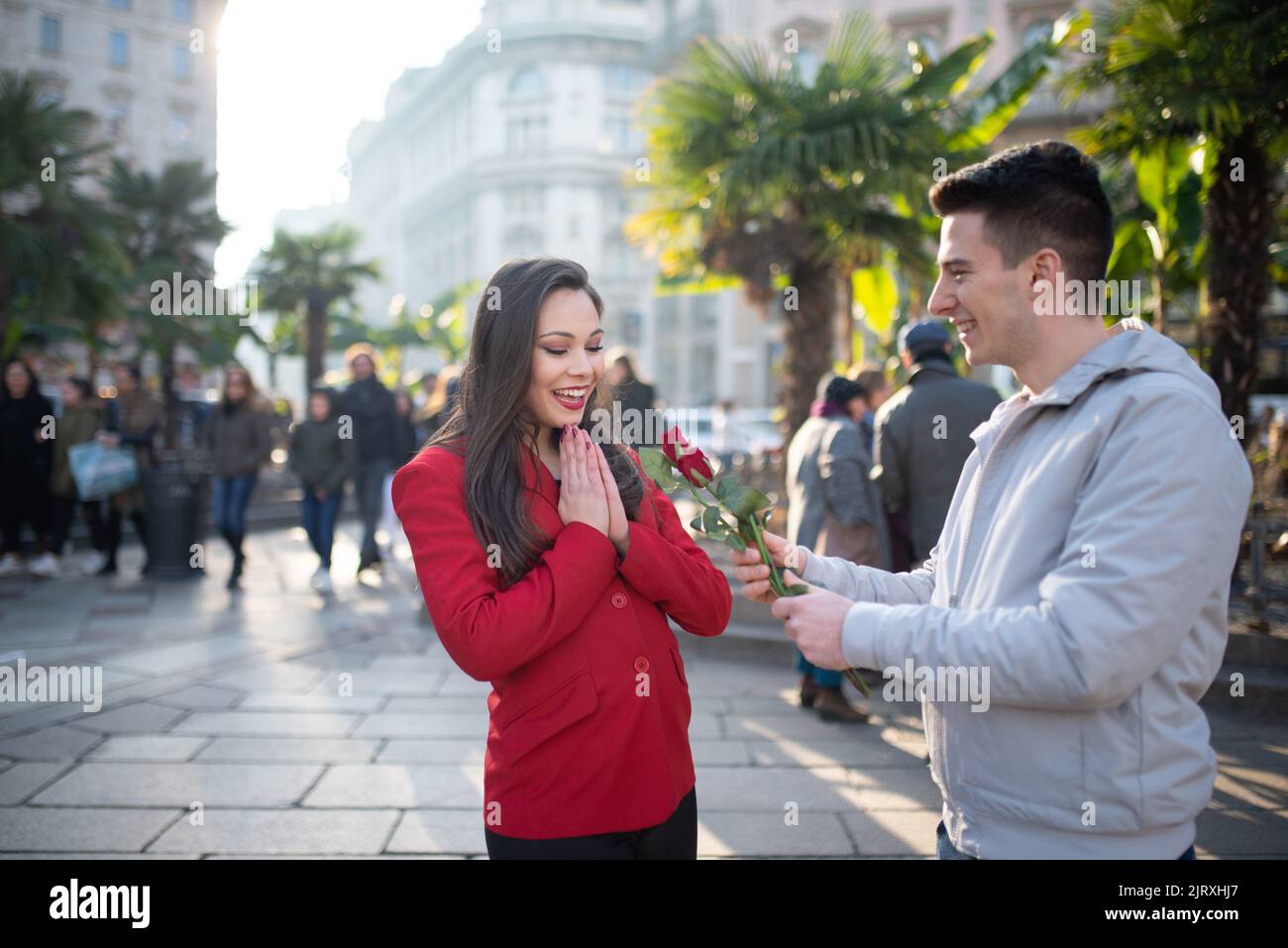 Guy giving a rose flower to his girlfriend Stock Photo - Alamy