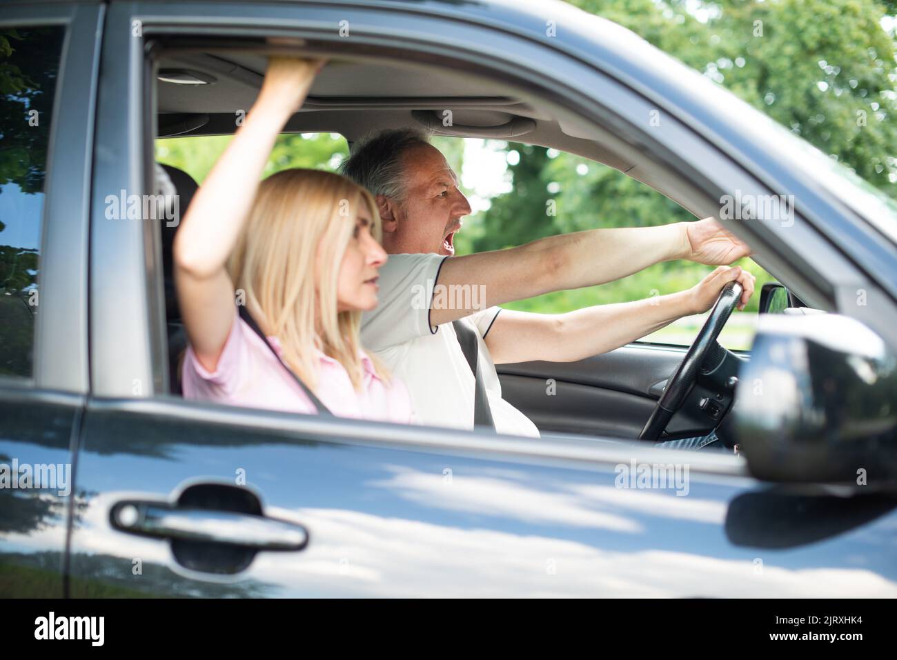 Angry driver shouting in his car, the lady is frightened Stock Photo ...