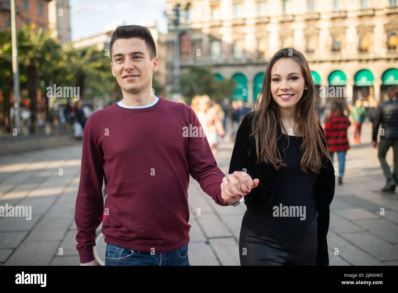 Couple walking together hand in hand in a city Stock Photo - Alamy