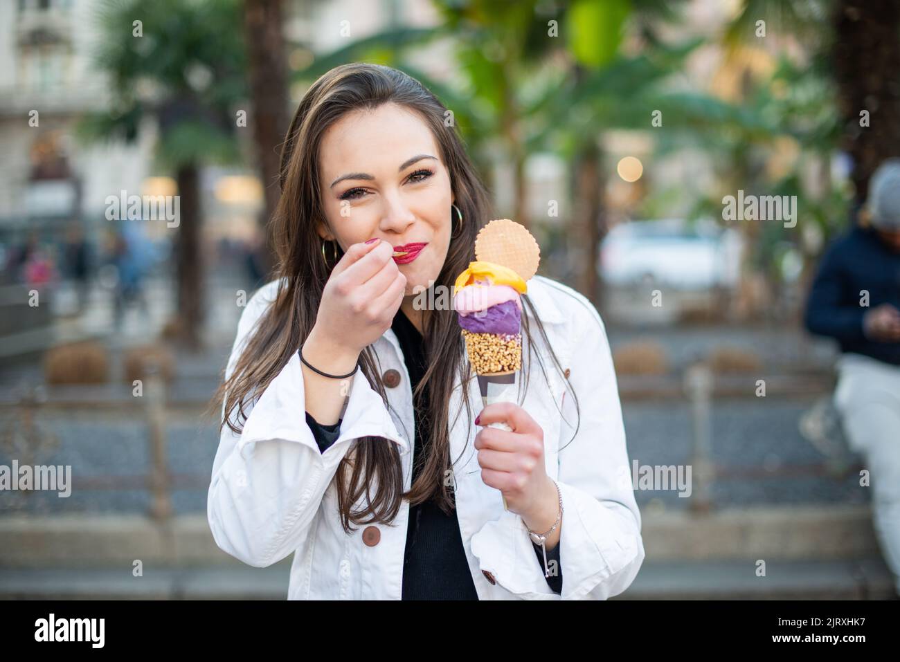 Woman eating a big ice cream cone outdoor Stock Photo - Alamy