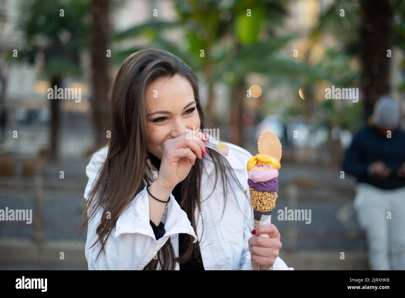 Woman eating a big ice cream cone outdoor Stock Photo - Alamy