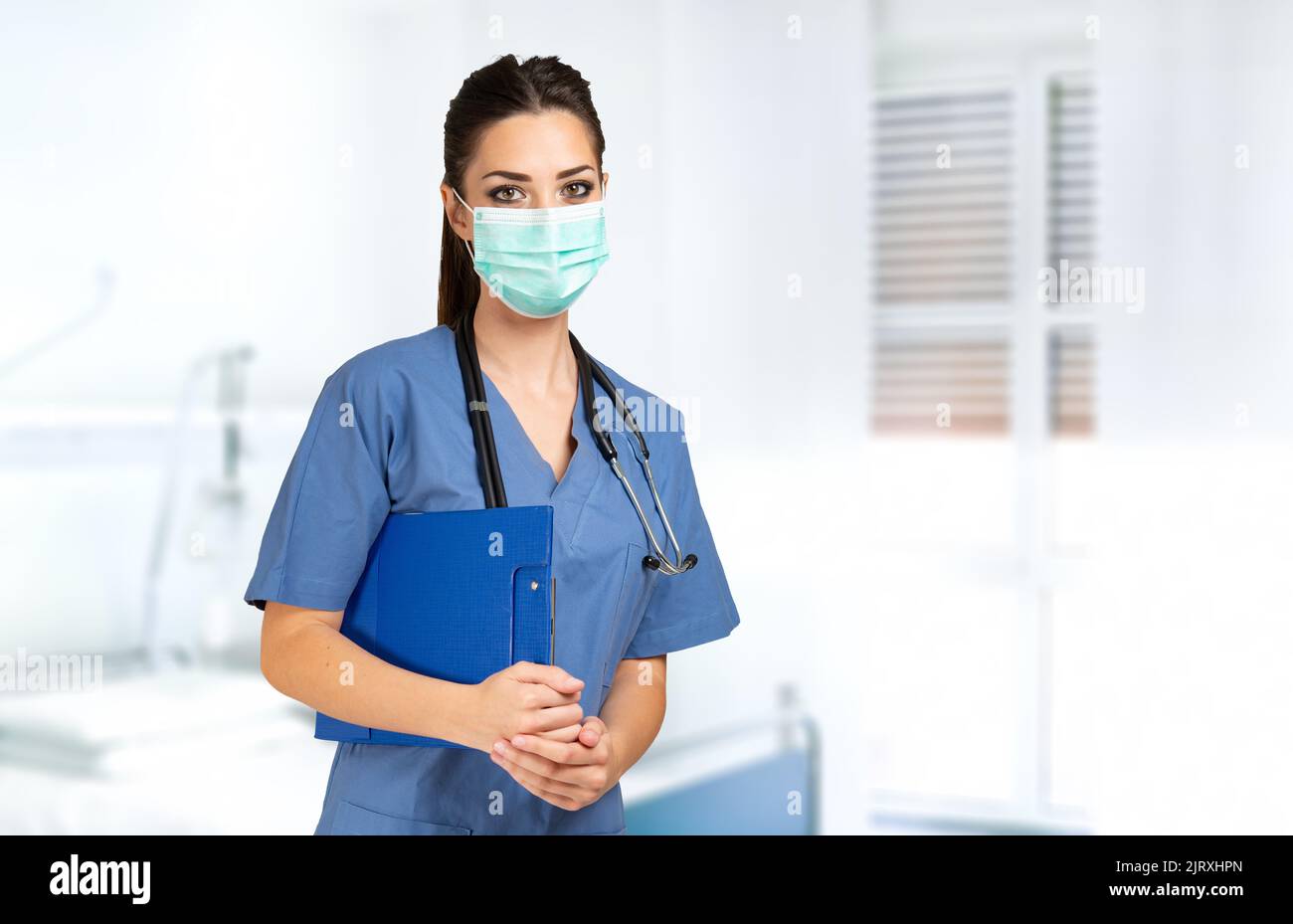Young masked female nurse portrait, covid coronavirus mask Stock Photo ...