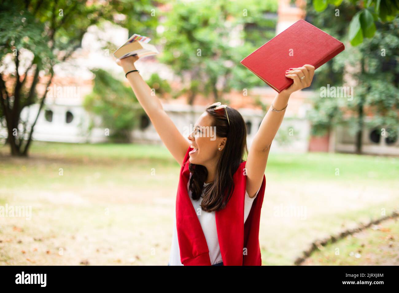 Portrait of an happy teenager student raising her arms Stock Photo - Alamy