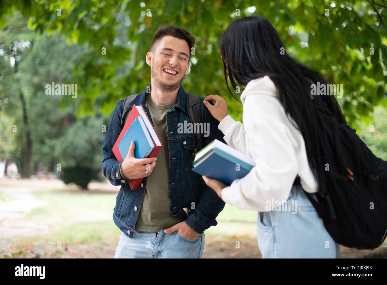 Two students studying together sitting on a outdoor Stock Photo - Alamy