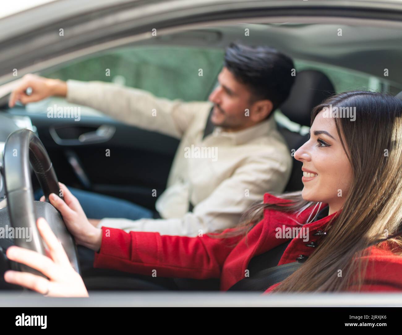 Young smiling woman driving her car Stock Photo - Alamy
