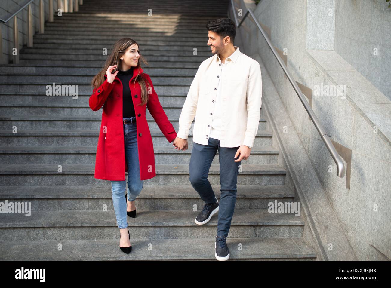 Young couple walking down stairs hi-res stock photography and images ...