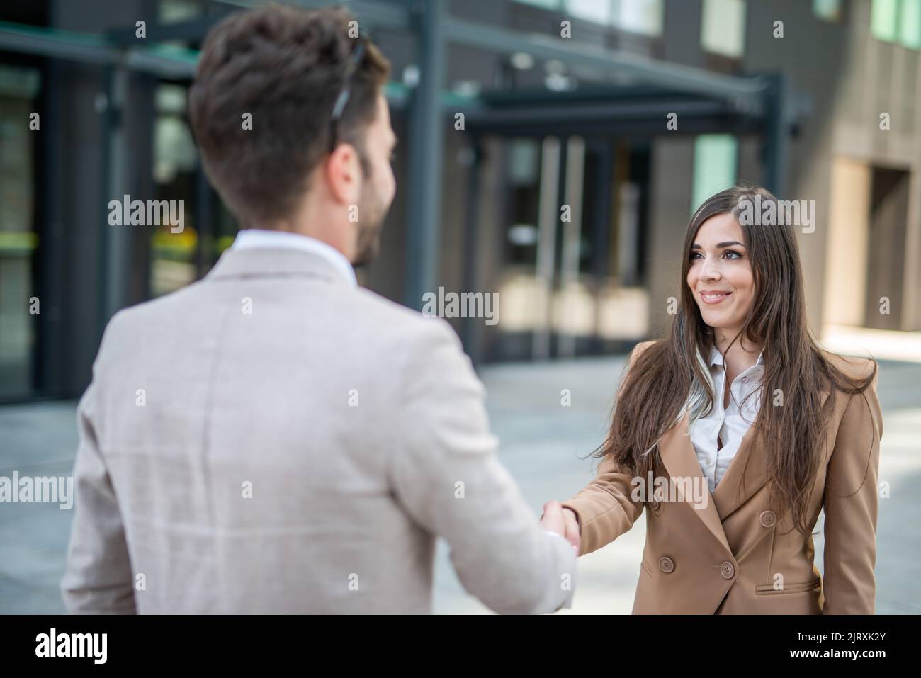 Smiling female manager shaking hands Stock Photo - Alamy