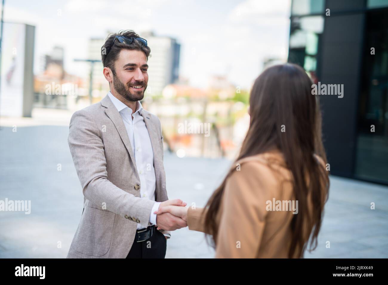 Smiling female manager shaking hands Stock Photo - Alamy