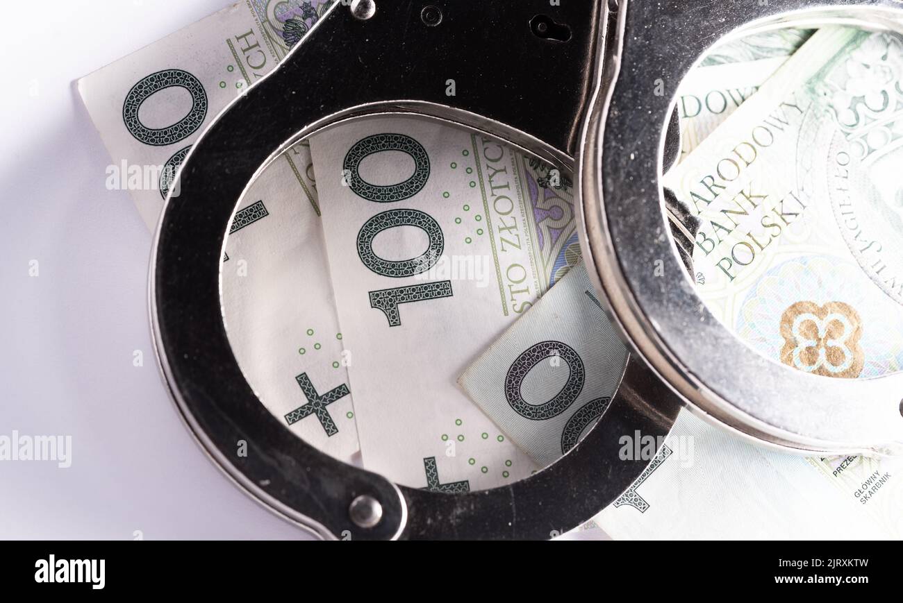 Police handcuffs and banknotes in Polish currency. The concept of ...
