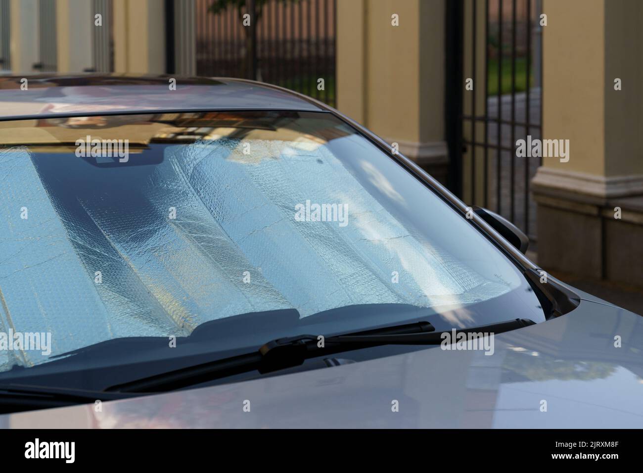 Protective reflective surface under windshield of car on hot day ...