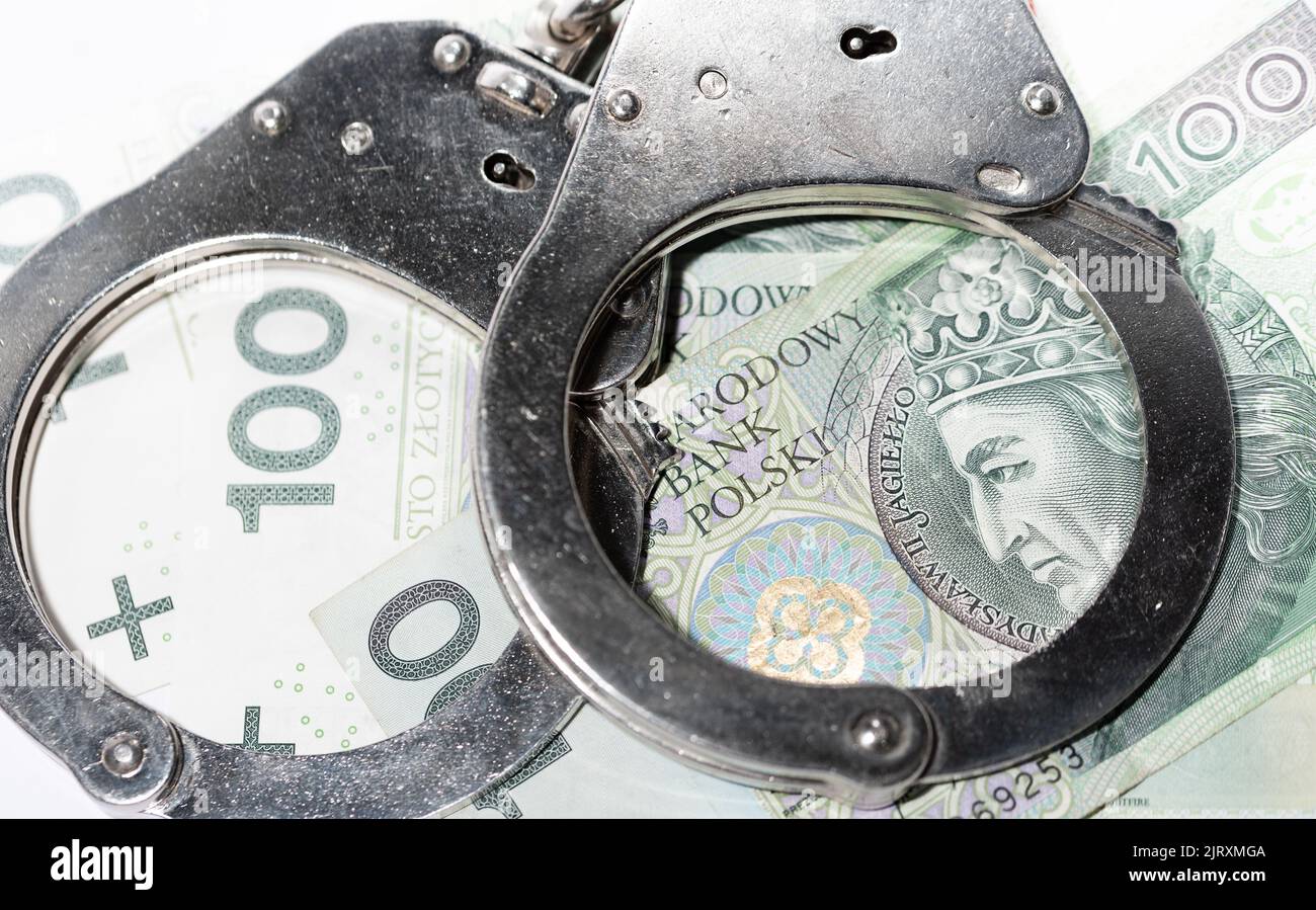 Police handcuffs and banknotes in Polish currency. The concept of ...