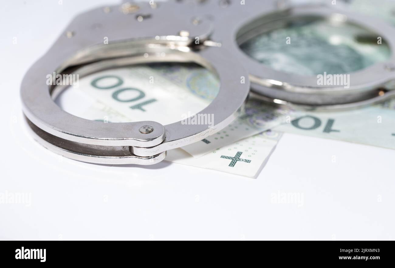 Police handcuffs and banknotes in Polish currency. The concept of ...