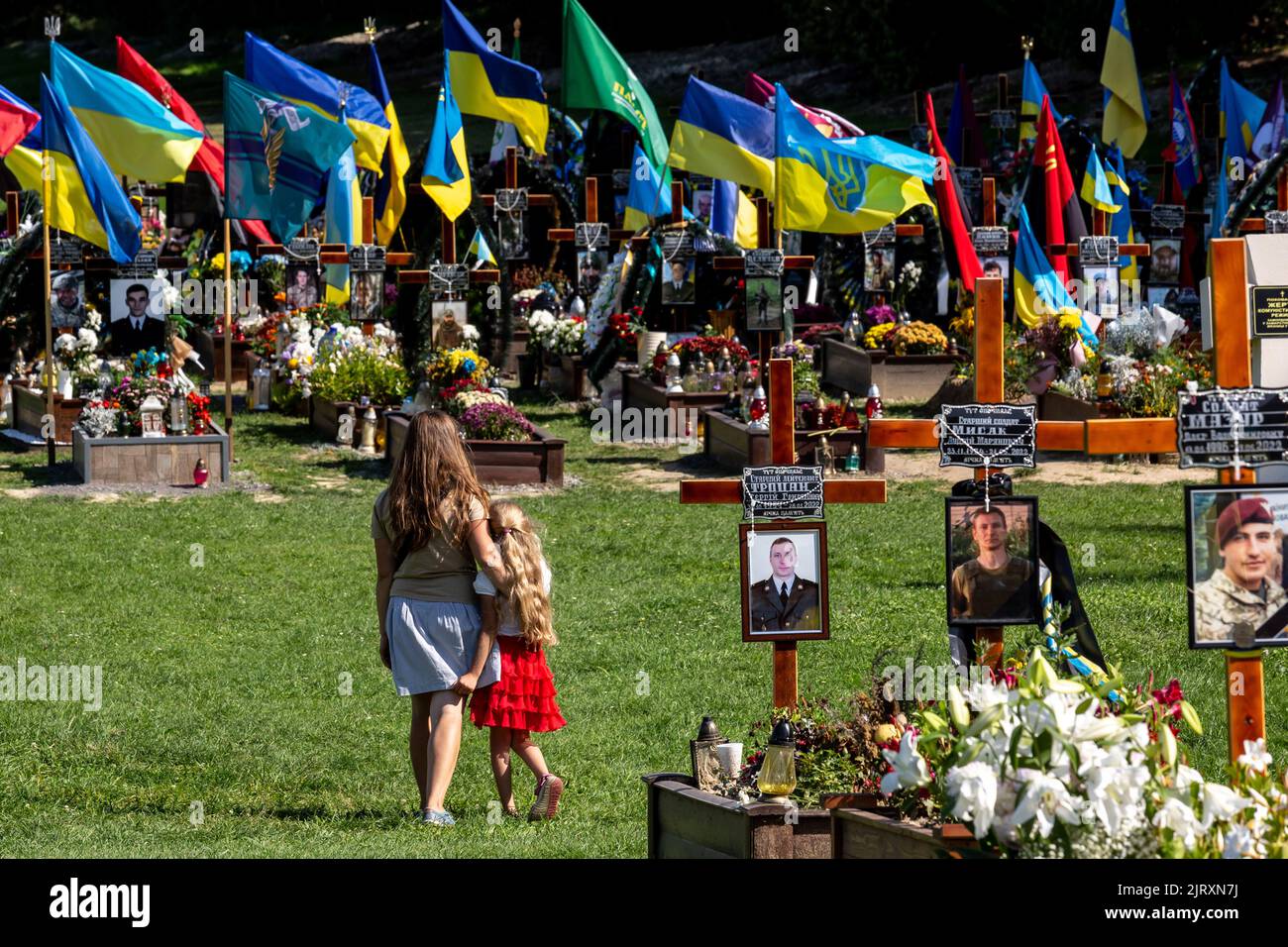A family arrives to pay respect at the graves of a fallen soldiers ...