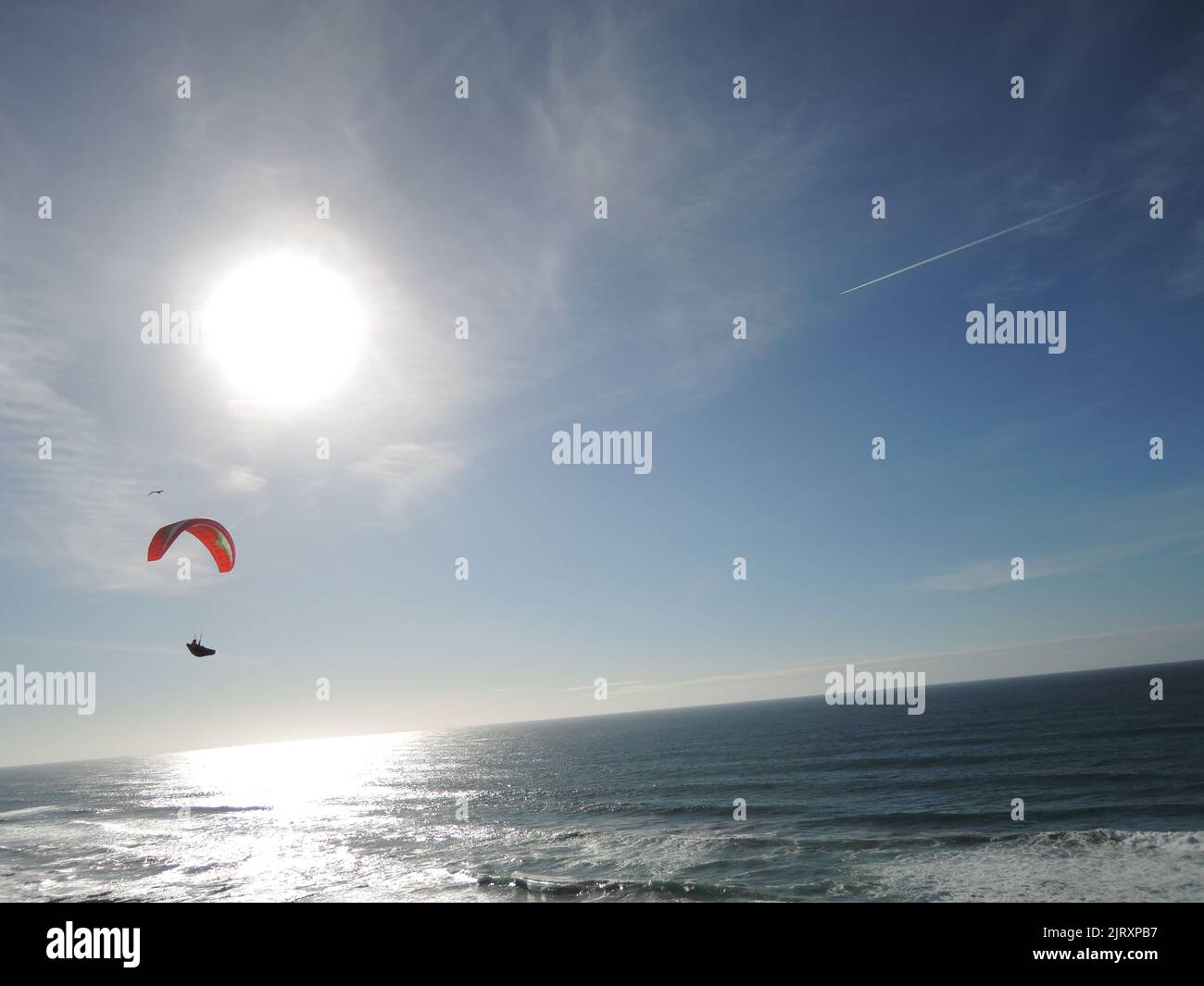 paragliding pilot flying in smooth air on colorfum paraglider wings in ...