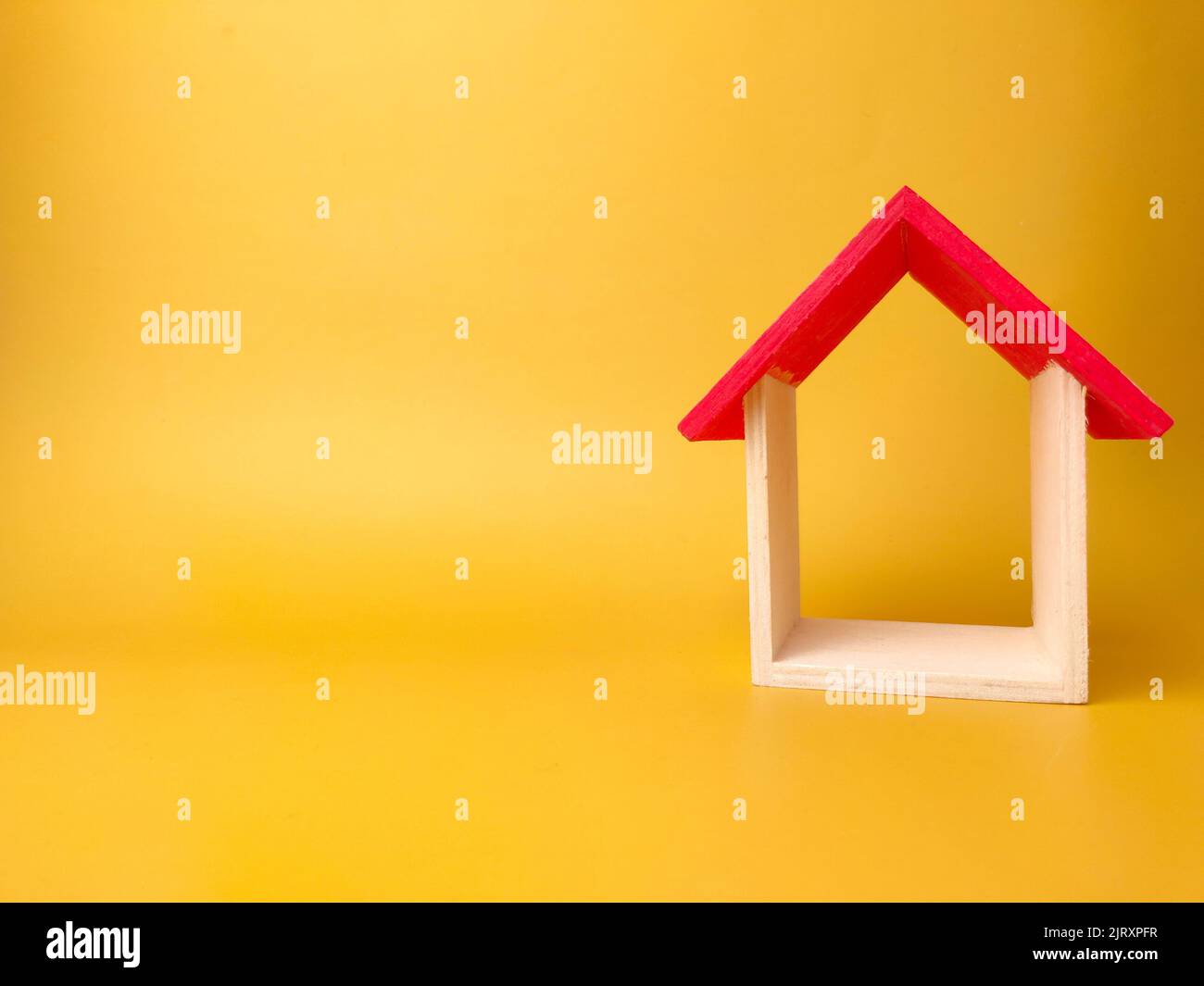 A wooden toy house isolated on yellow background with copy space Stock ...