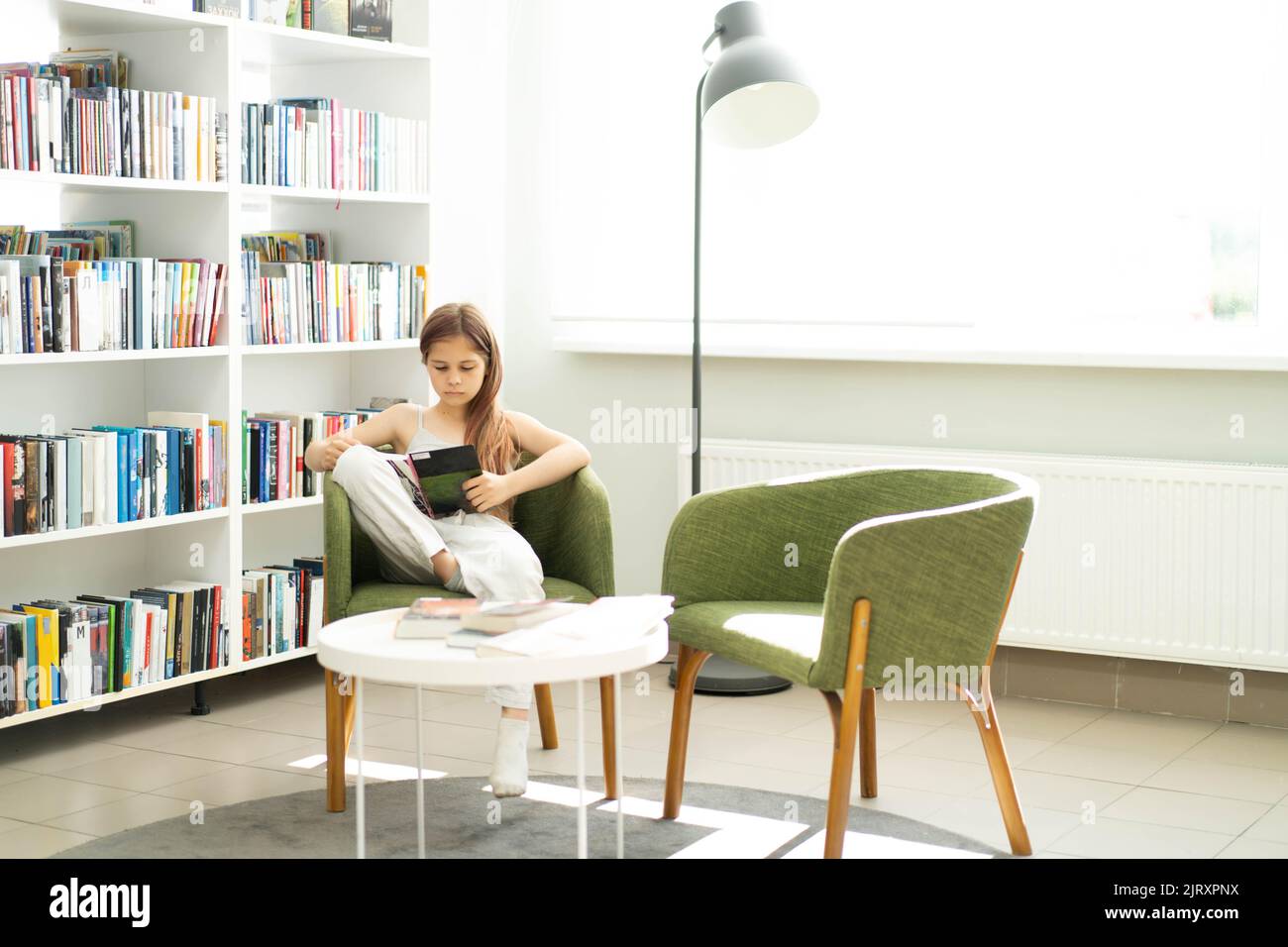 Person reading in a library hi-res stock photography and images - Alamy