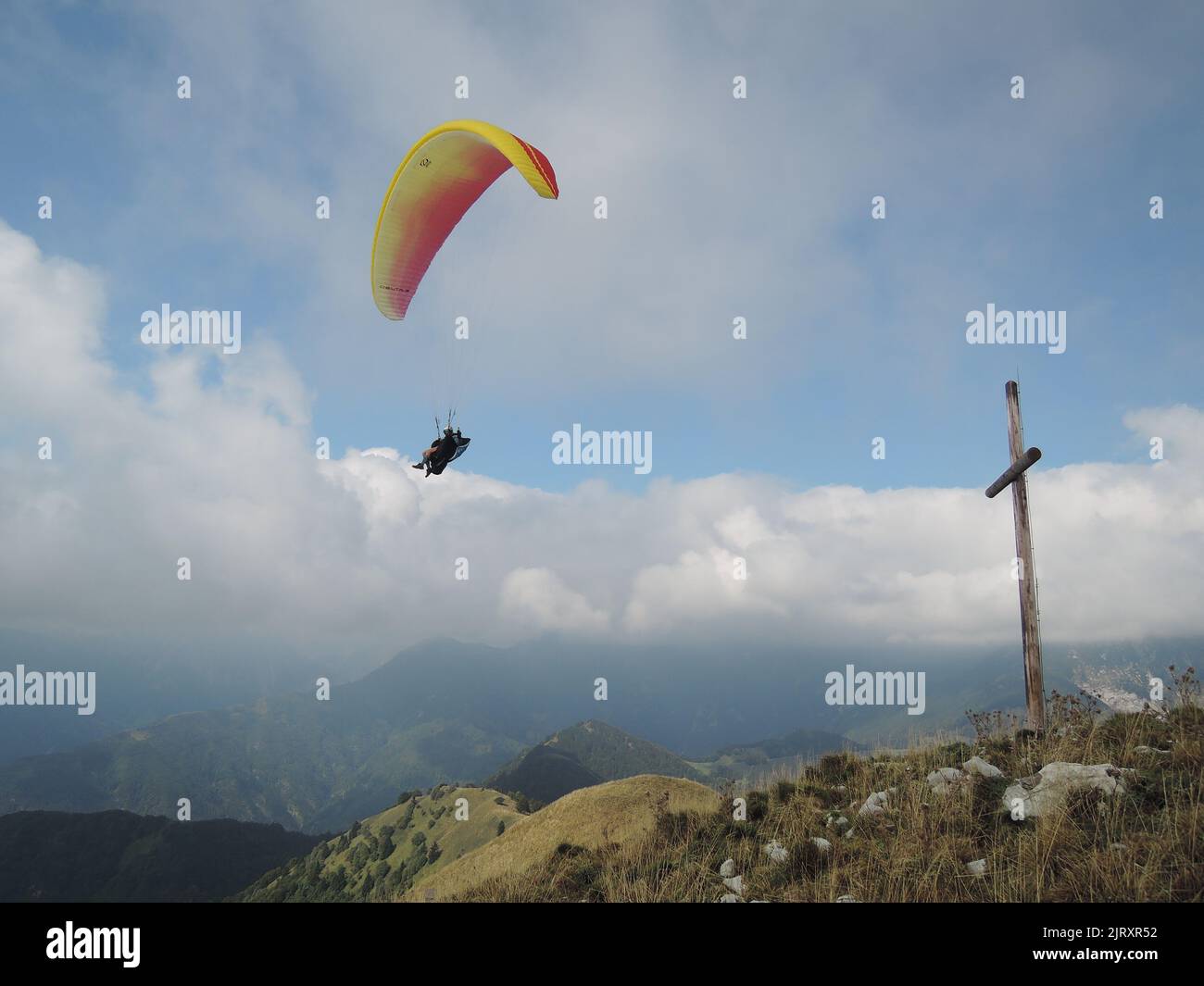 paragliding pilot flying in smooth air on colorfum paraglider wings in ...