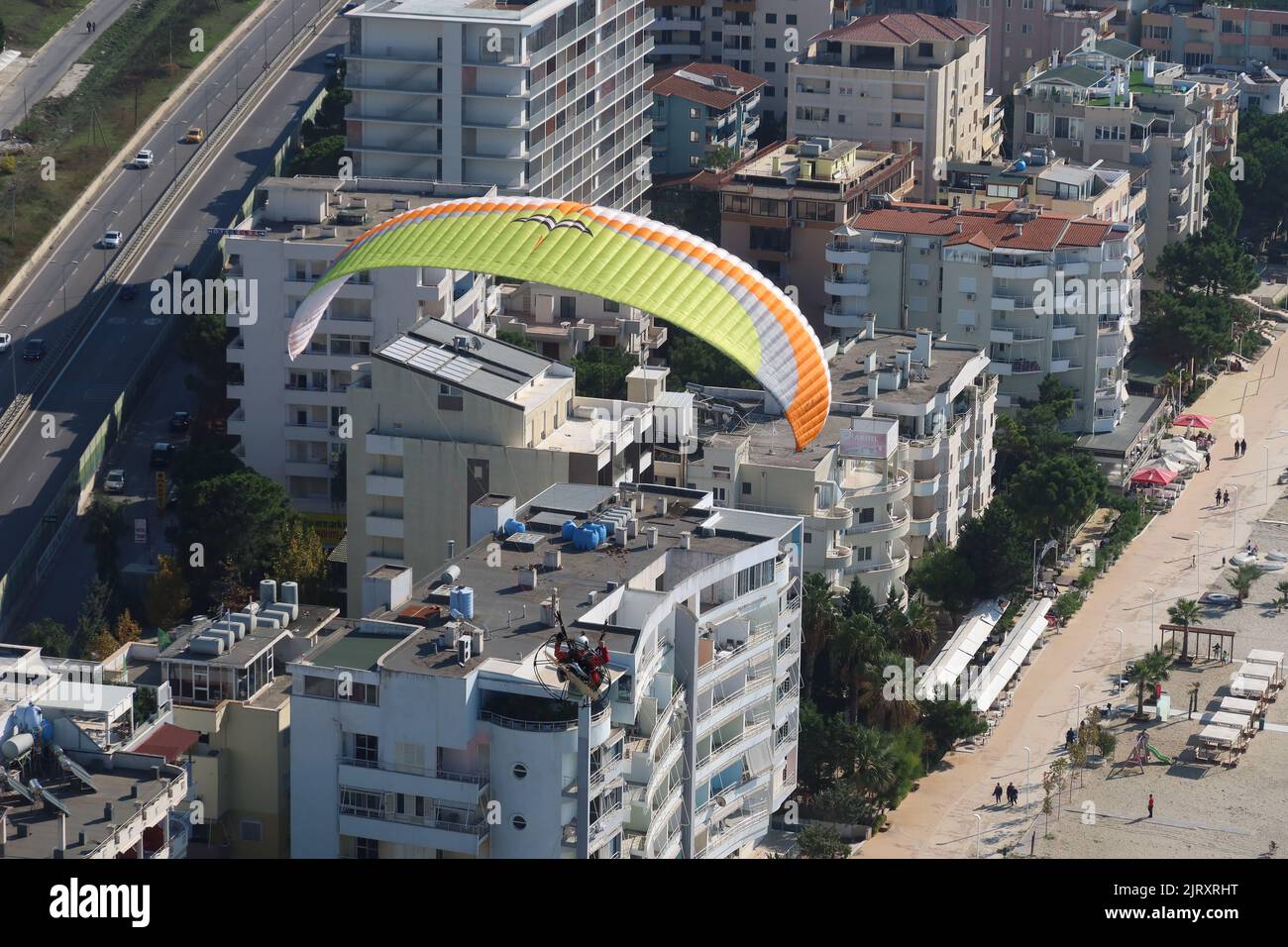 paragliding pilot flying in smooth air on colorfum paraglider wings in ...