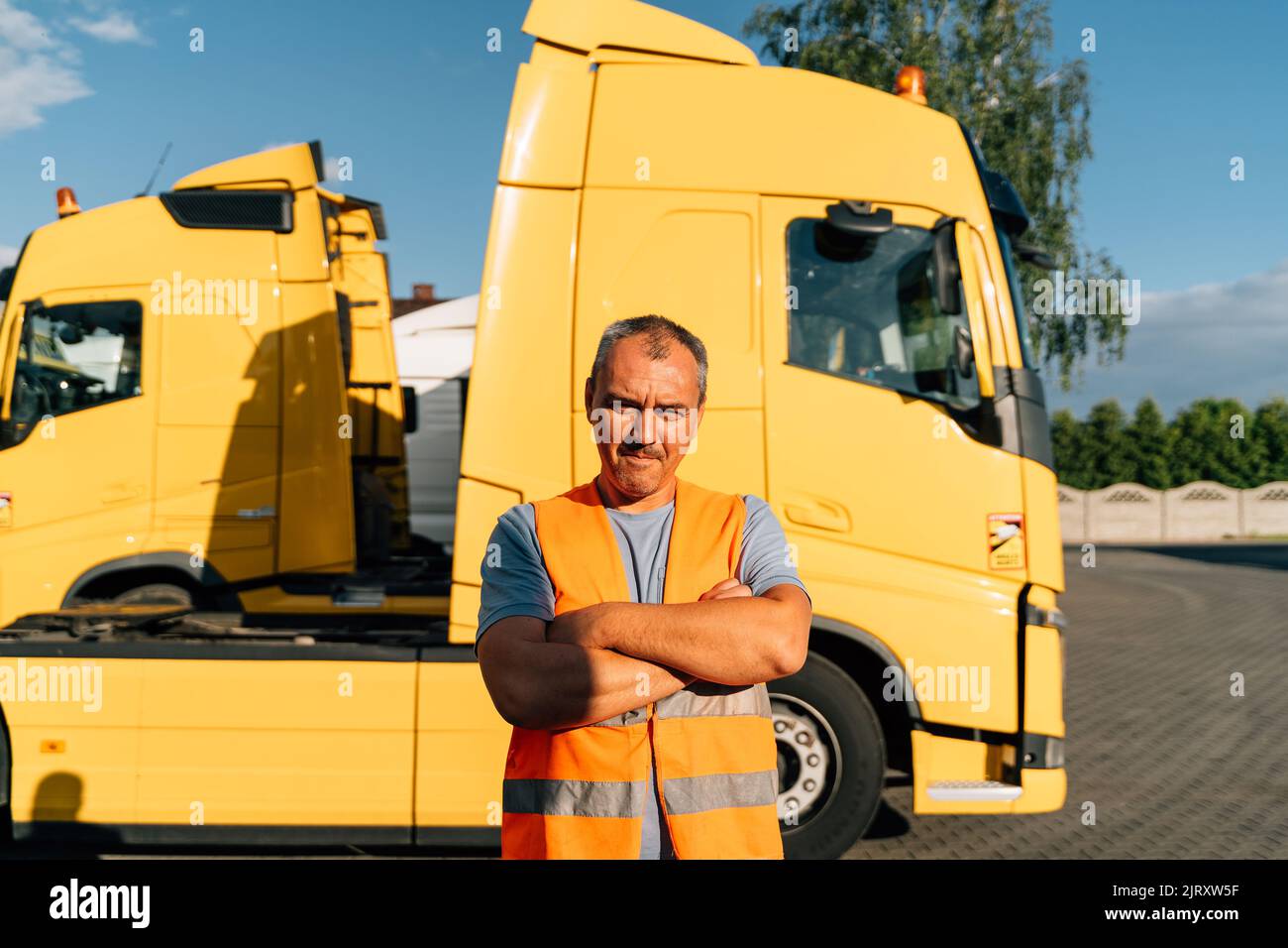 Portrait of caucasian mature man on semi-truck vehicles parking ...
