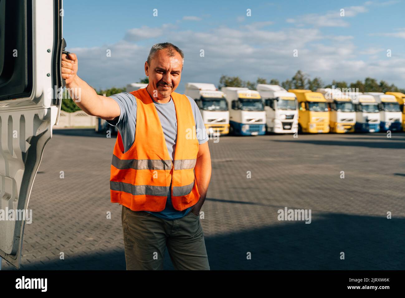 Portrait of caucasian mature man on semi-truck vehicles parking ...