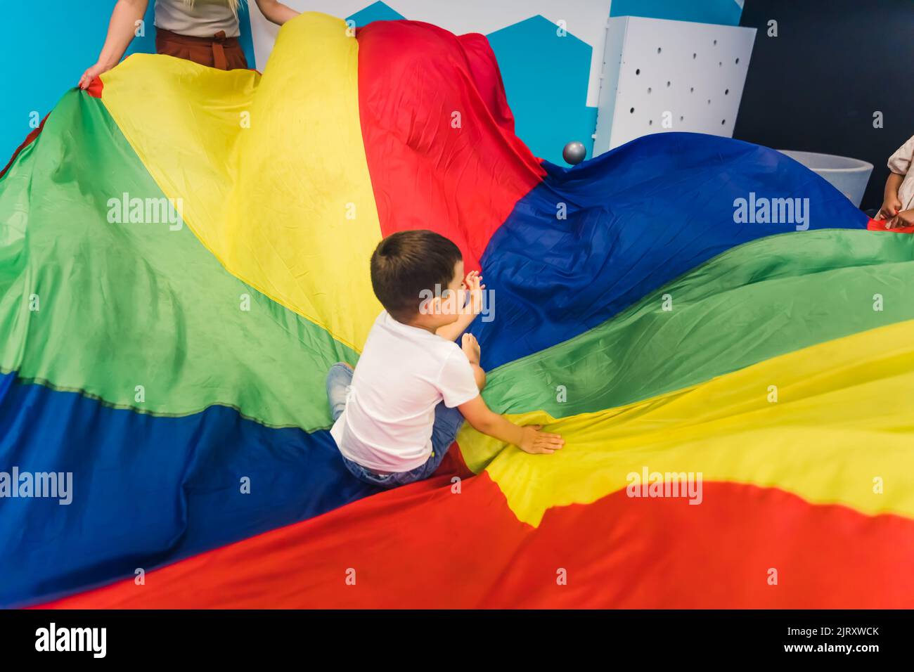 Happy toddlers having an active sensory play with texture and colors at ...