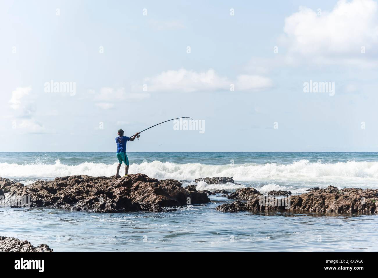 A Fisherman with fishing rod on the rocks fishing on the famous Boca do ...