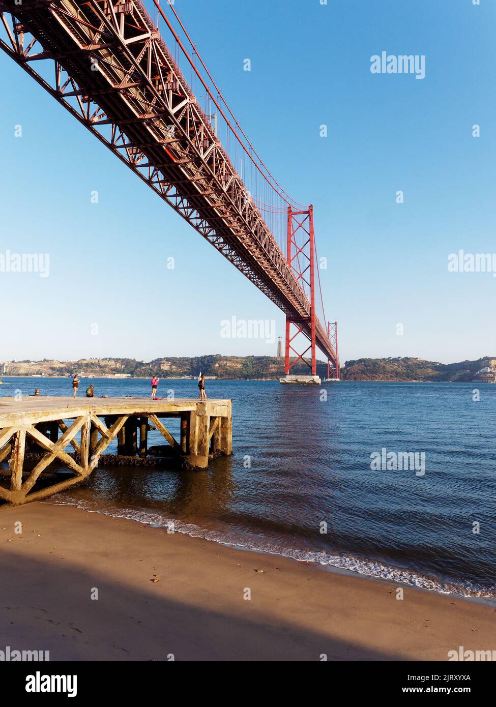 The Ponte 25 de Abril (25th of April Bridge) spanning the river Tagus ...