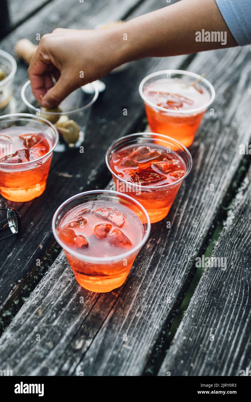 Making aperol spritz cocktails outdoors on picnic table Stock Photo - Alamy