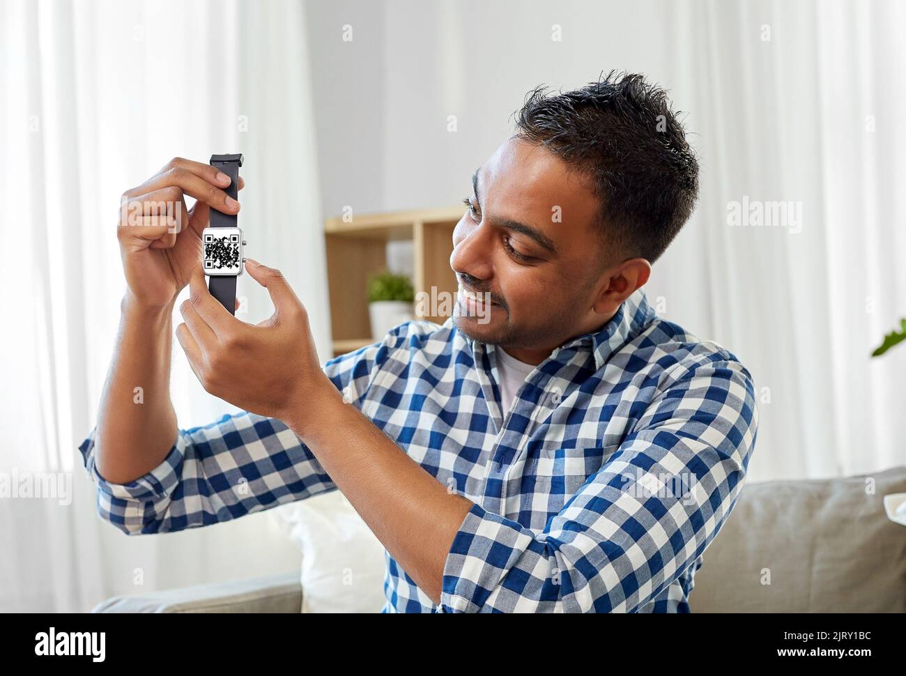 man showing smart watch with qr code on screen Stock Photo - Alamy